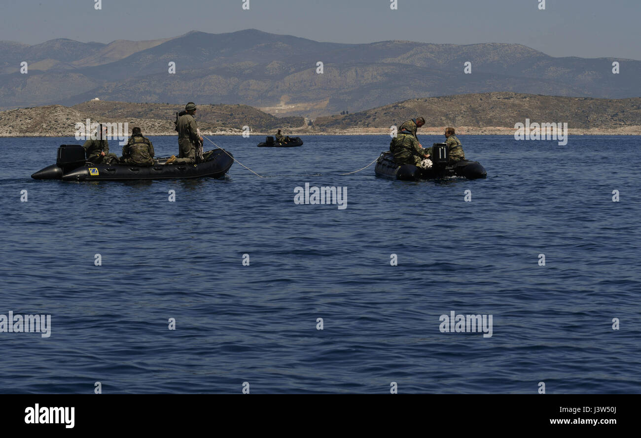 Greek servicemembers gather a sea-rescue kit out of the Mediterranean ...