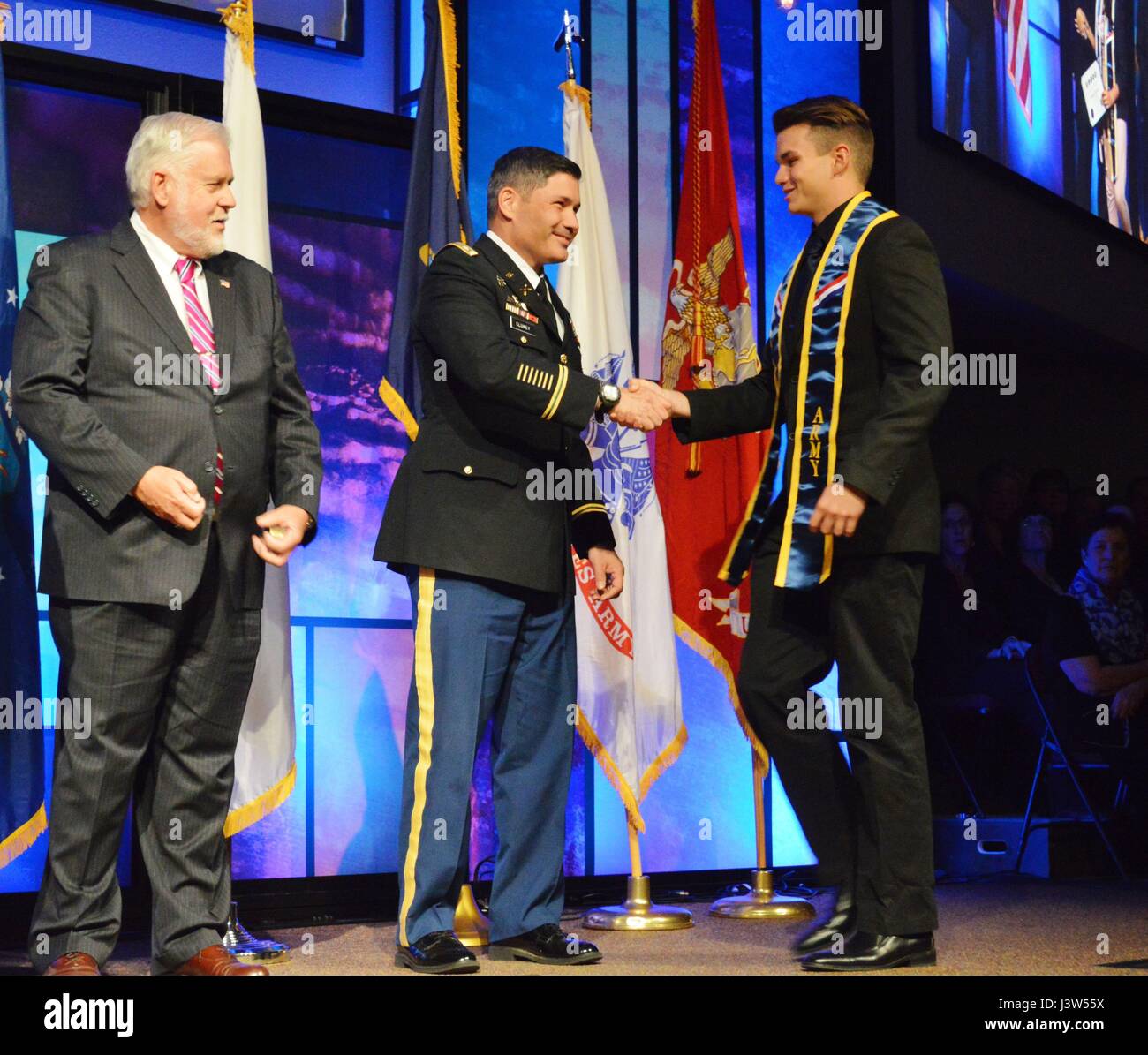 Watched by Glendale Mayor Jerry Weiers (left), Lt. Col. David Clukey ...