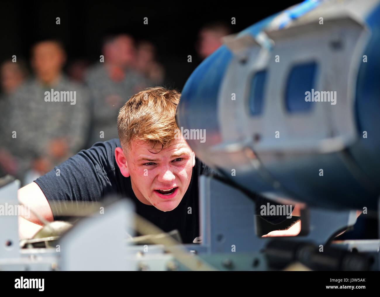 An Air Force weapons crew member loads munitions during the Load Crew ...