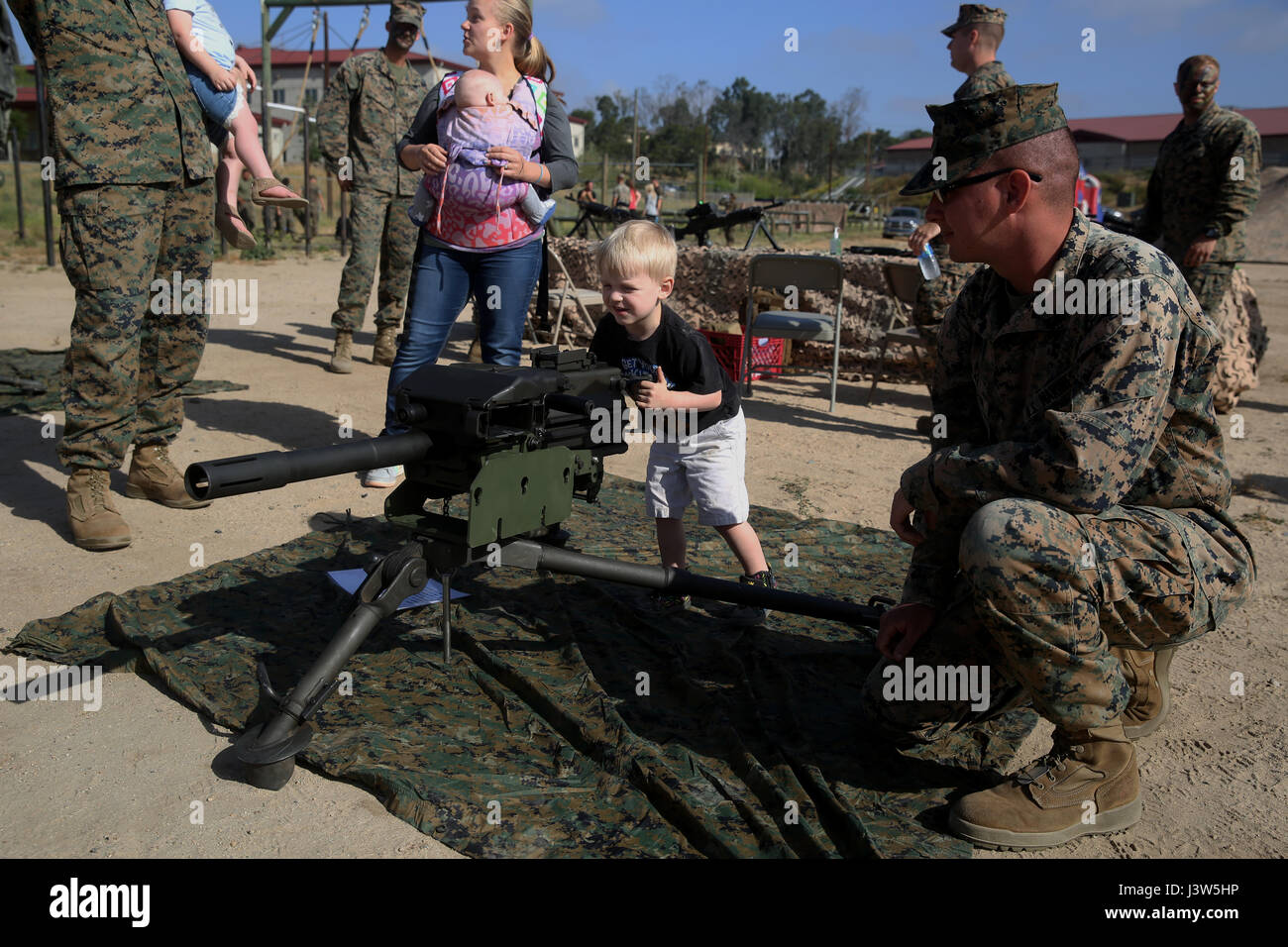 A child learns how to use a Mark 19 grenade launcher during the 9th ...