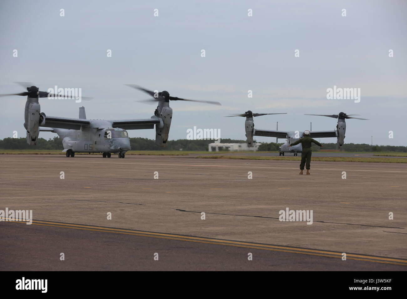 A Marine with Marine Tiltrotor Squadron (VMM) 268 guides an MV-22B Osprey into position after ...