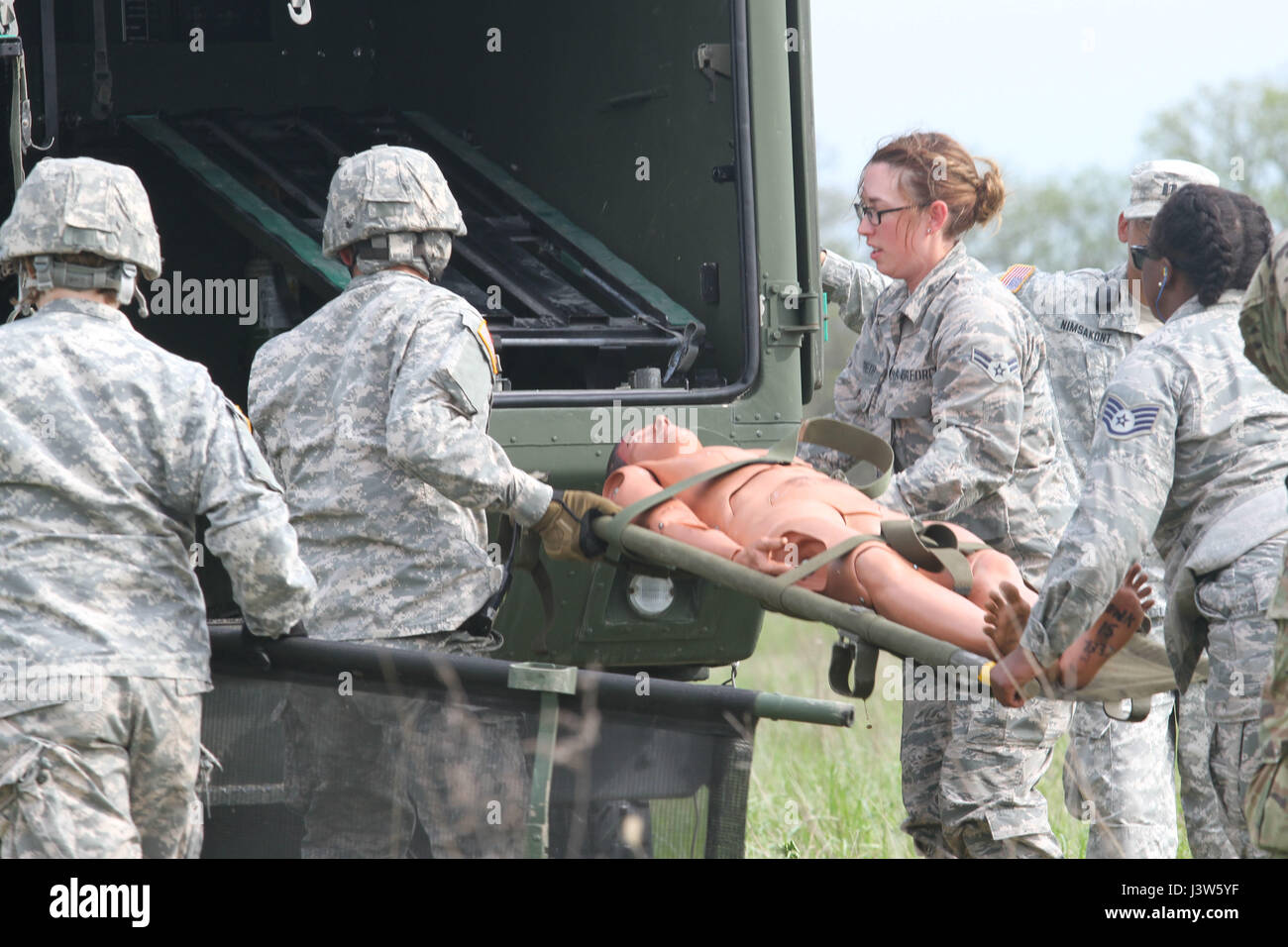 Army and Air Force personnel load a mannequin into a M997 HMMWV during ...