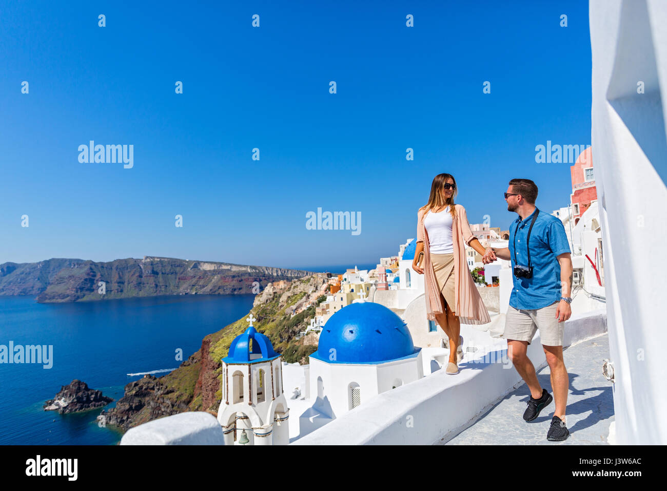 Young couple walking on the island of Santorini, Greece Stock Photo - Alamy
