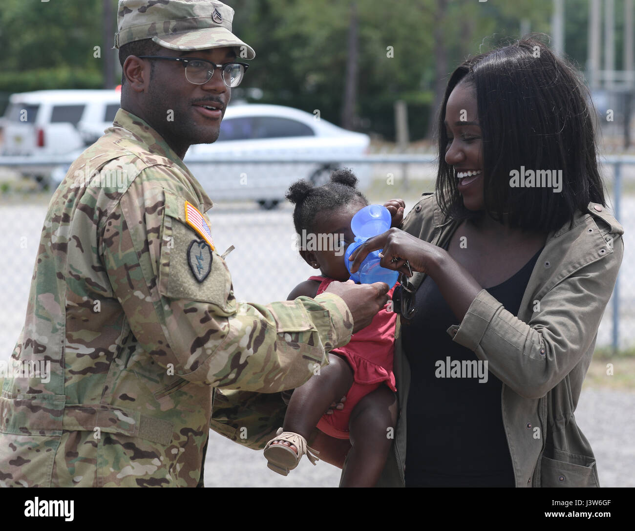 Staff Sgt. Chad Butler reunites with his wife, Cassie, and his daughter ...