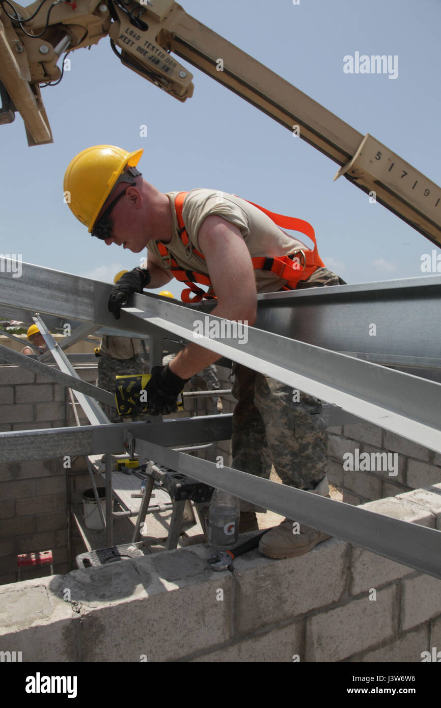 U.S. Army Spc. Chris Bebo, with the 372nd Engineer Company, directs the ...