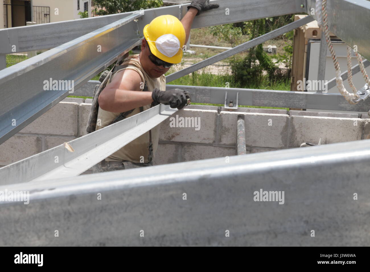 A U.S. Soldier, with the 372nd Engineer Company, positions a beam on ...