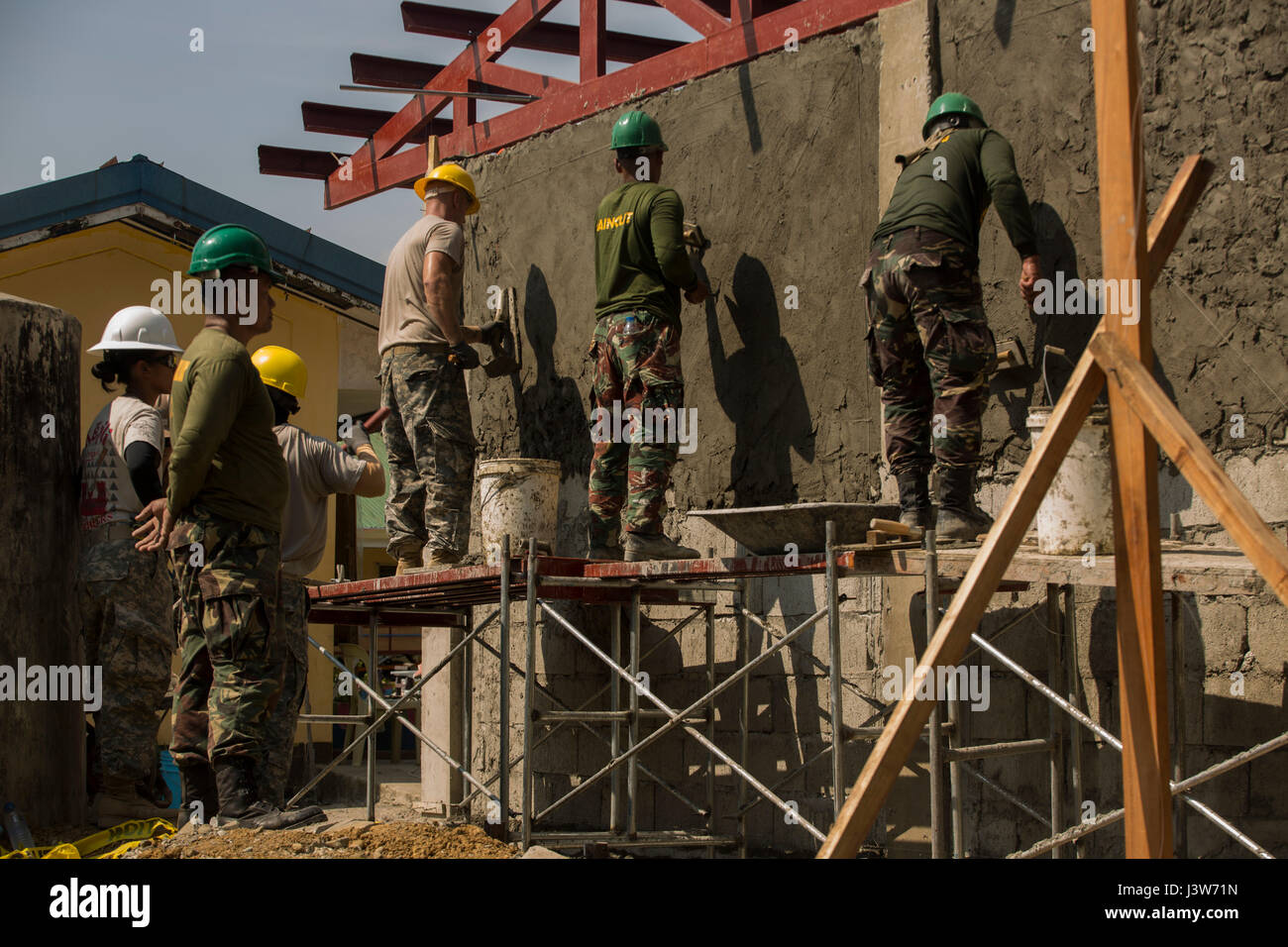 U.S. and Philippine service members apply plaster at Malitbog ...