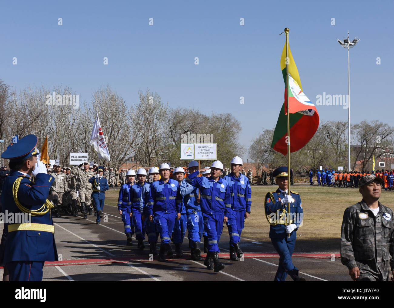 A multinational formation of troops conduct a pass in review during the ...