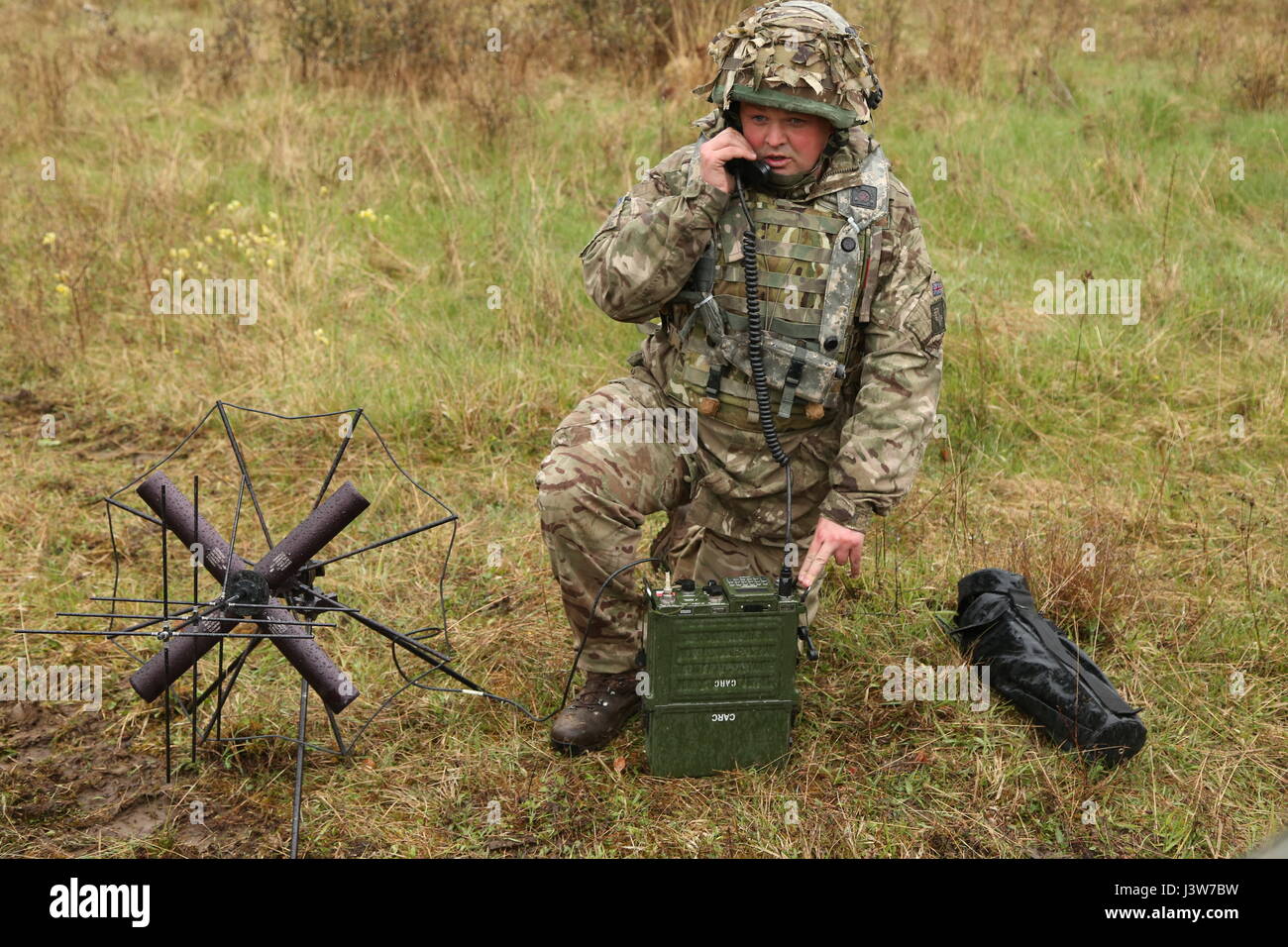 British Army Cpl. Samuel Evitt of the Queens Royal Hussars radios for ...