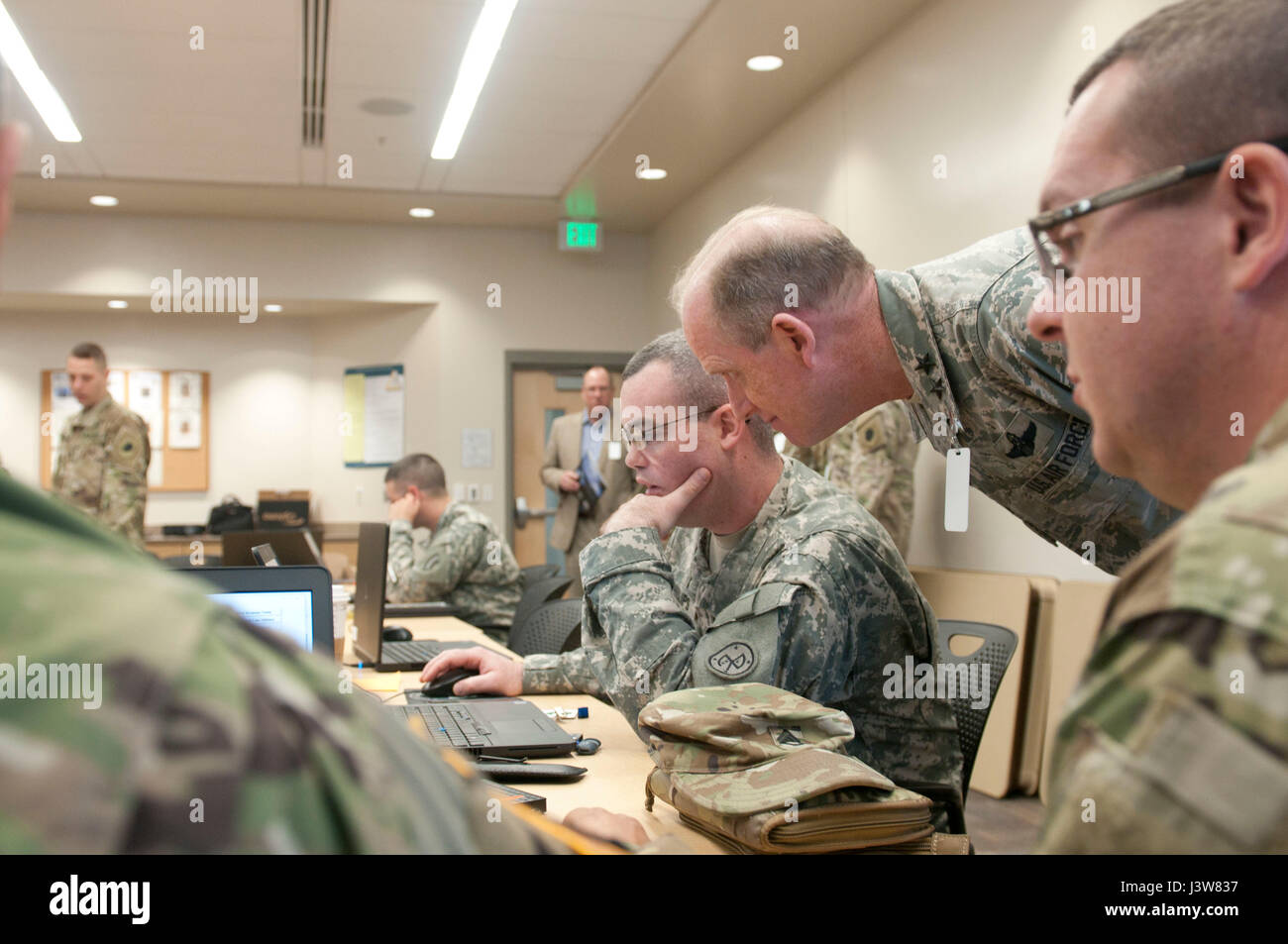 Maj. Gen. Don Dunbar watches the screen of a cyber forensics trainee ...