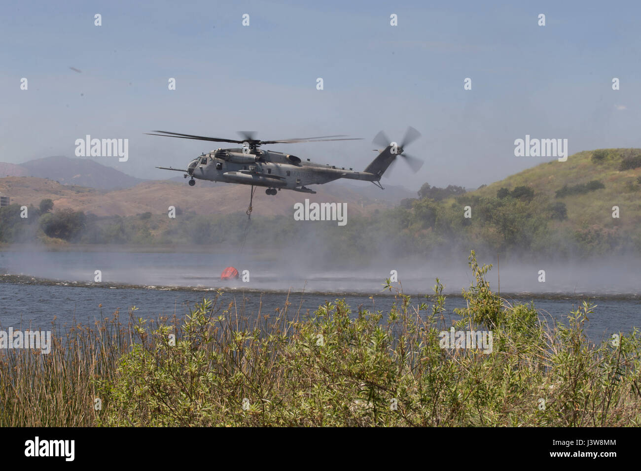 U.S. Marine Corps CH-53E Super Stallion lowers its bambi bucket to ...