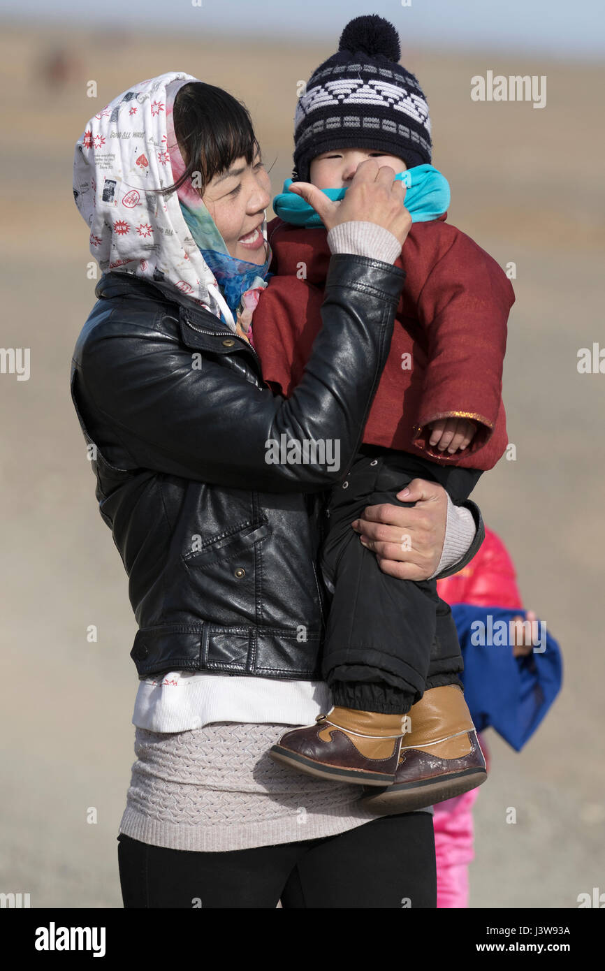 A mother and child of Dalanzadgad, Mongolia, evacuate to collection ...