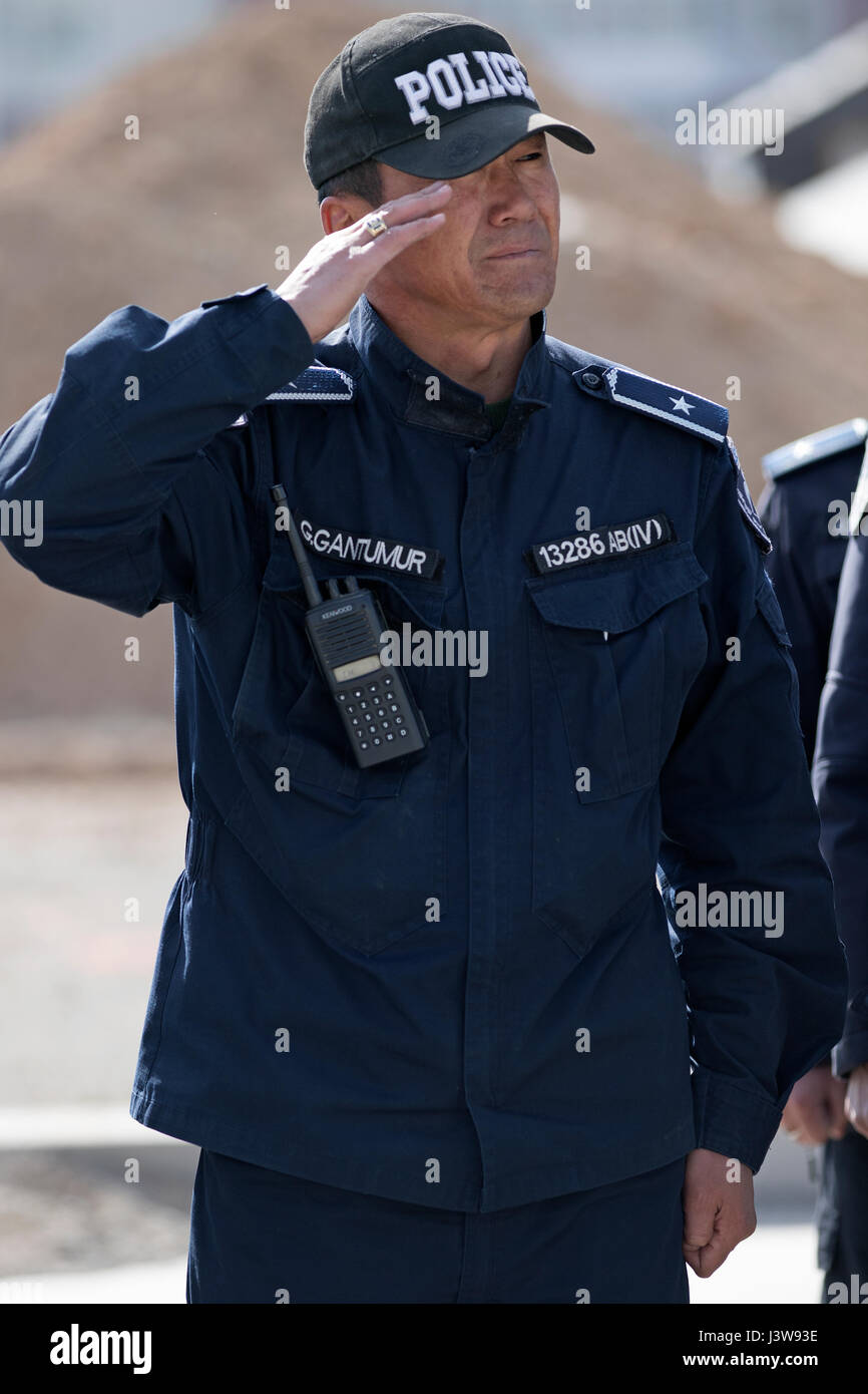 Gantumur, a Dalanzadgad police officer, renders honors during a prelude ...