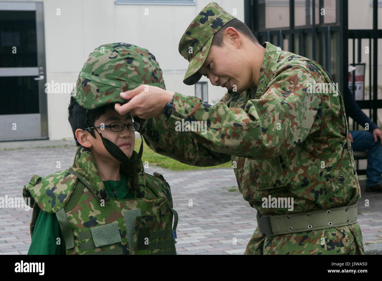 A Japanese Ground Self Defense Force (JGSDF) member places a kevlar ...