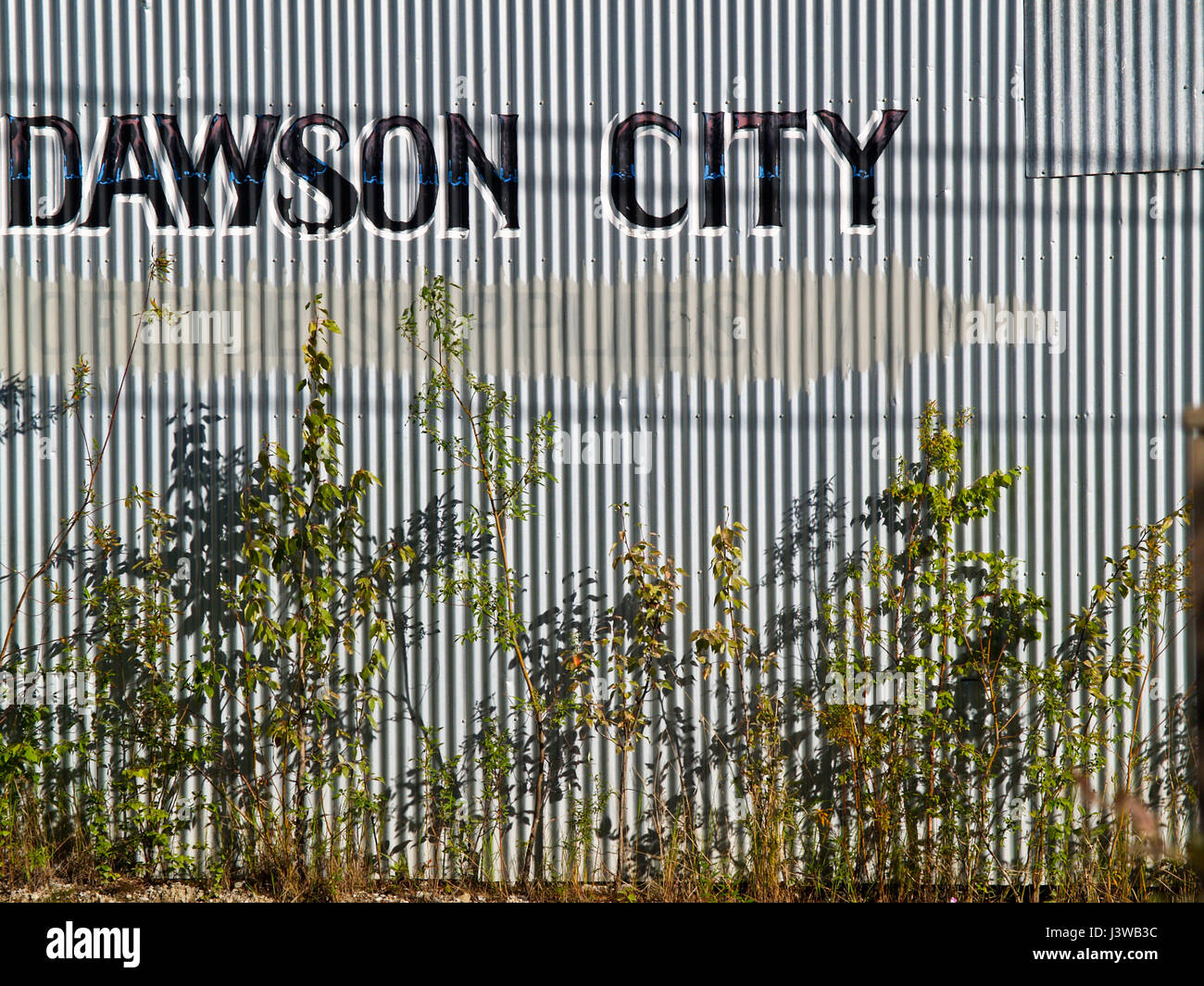 Dawson City sign hand painted on corrugated iron wall Stock Photo - Alamy