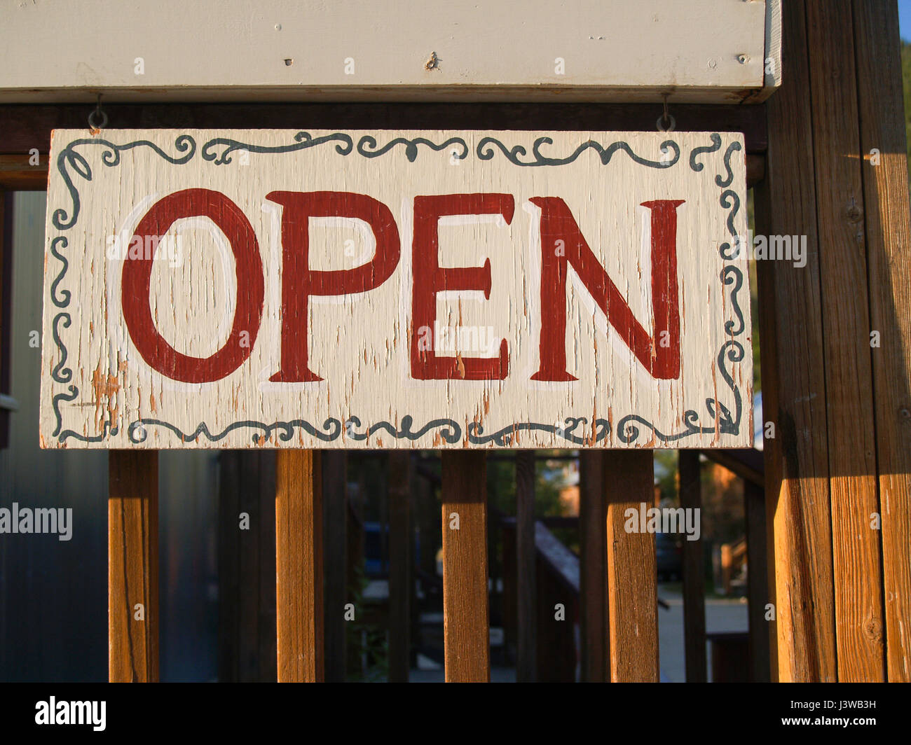 Hand painted open sign on exterior of building Stock Photo - Alamy