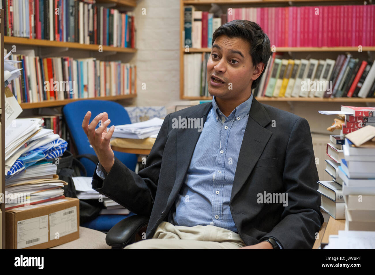 Rana Mitter surrounded by books at Oxford University Stock Photo - Alamy
