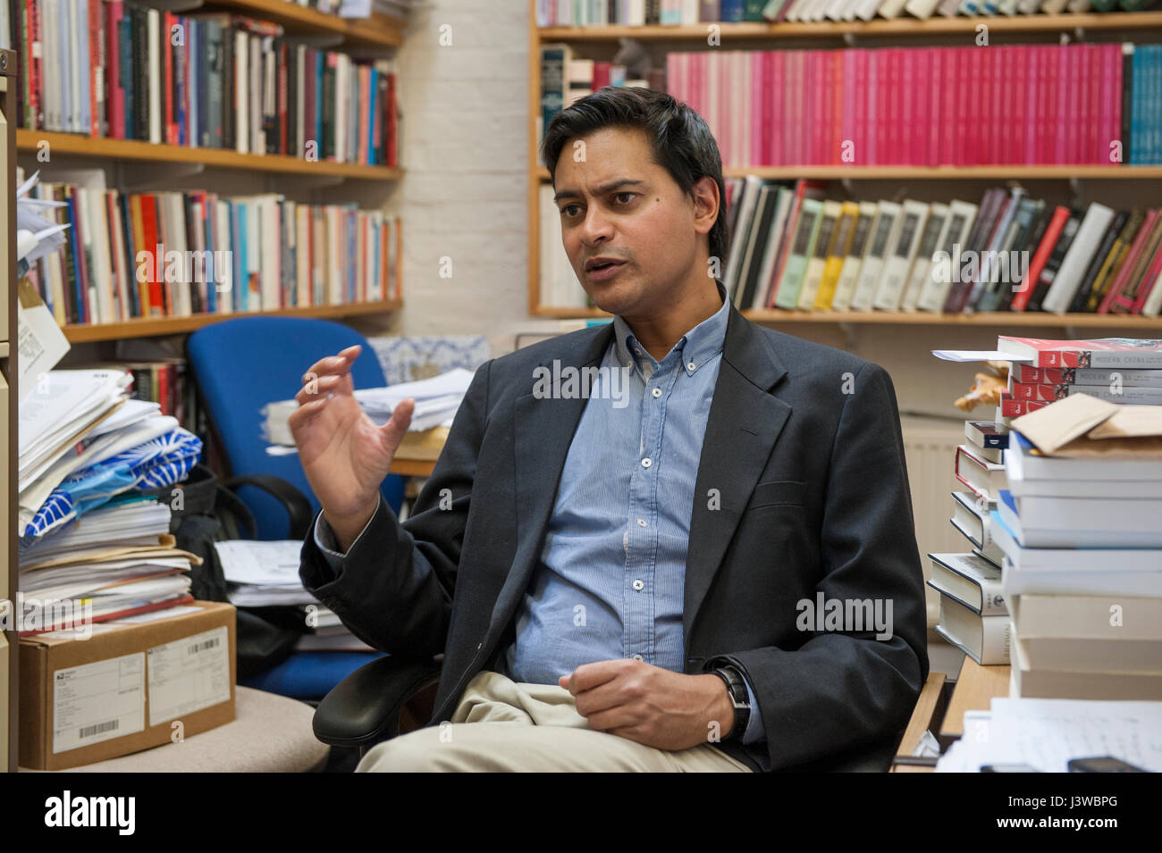 Rana Mitter surrounded by books at Oxford University Stock Photo - Alamy