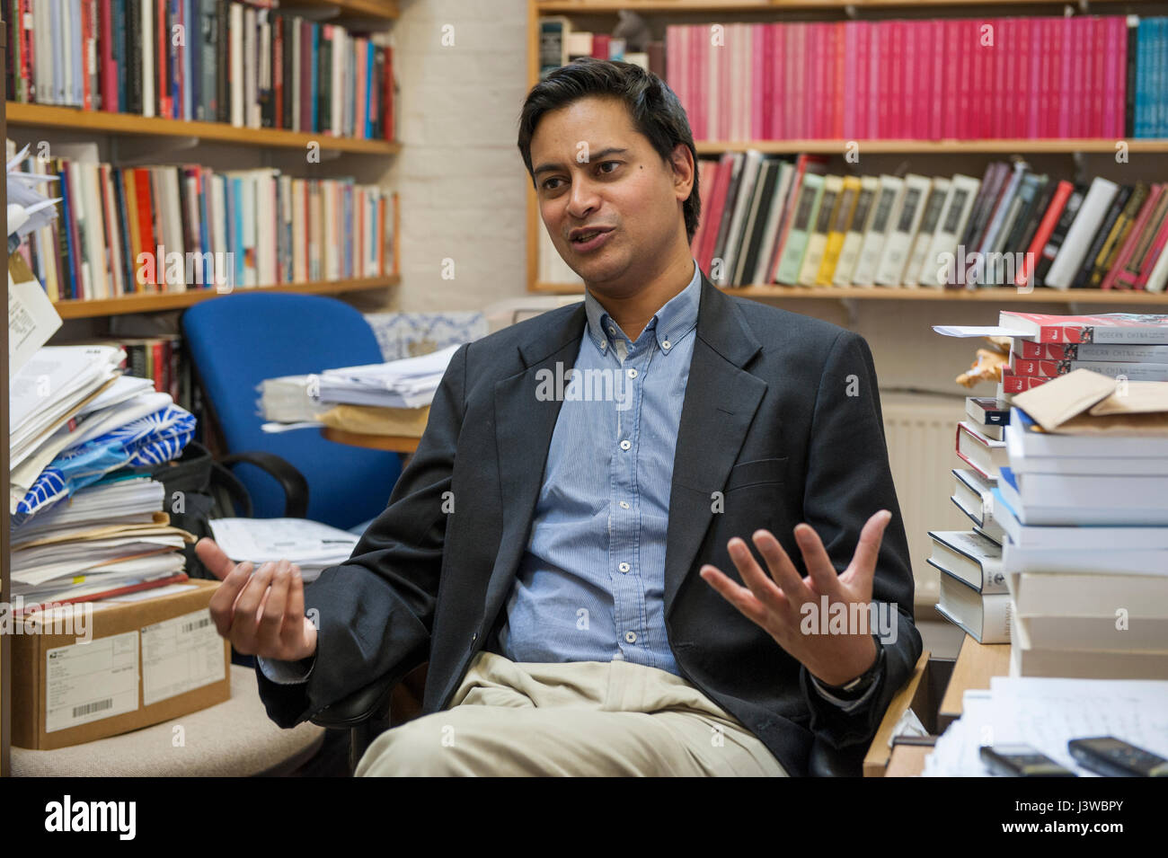 Rana Mitter surrounded by books at Oxford University Stock Photo - Alamy