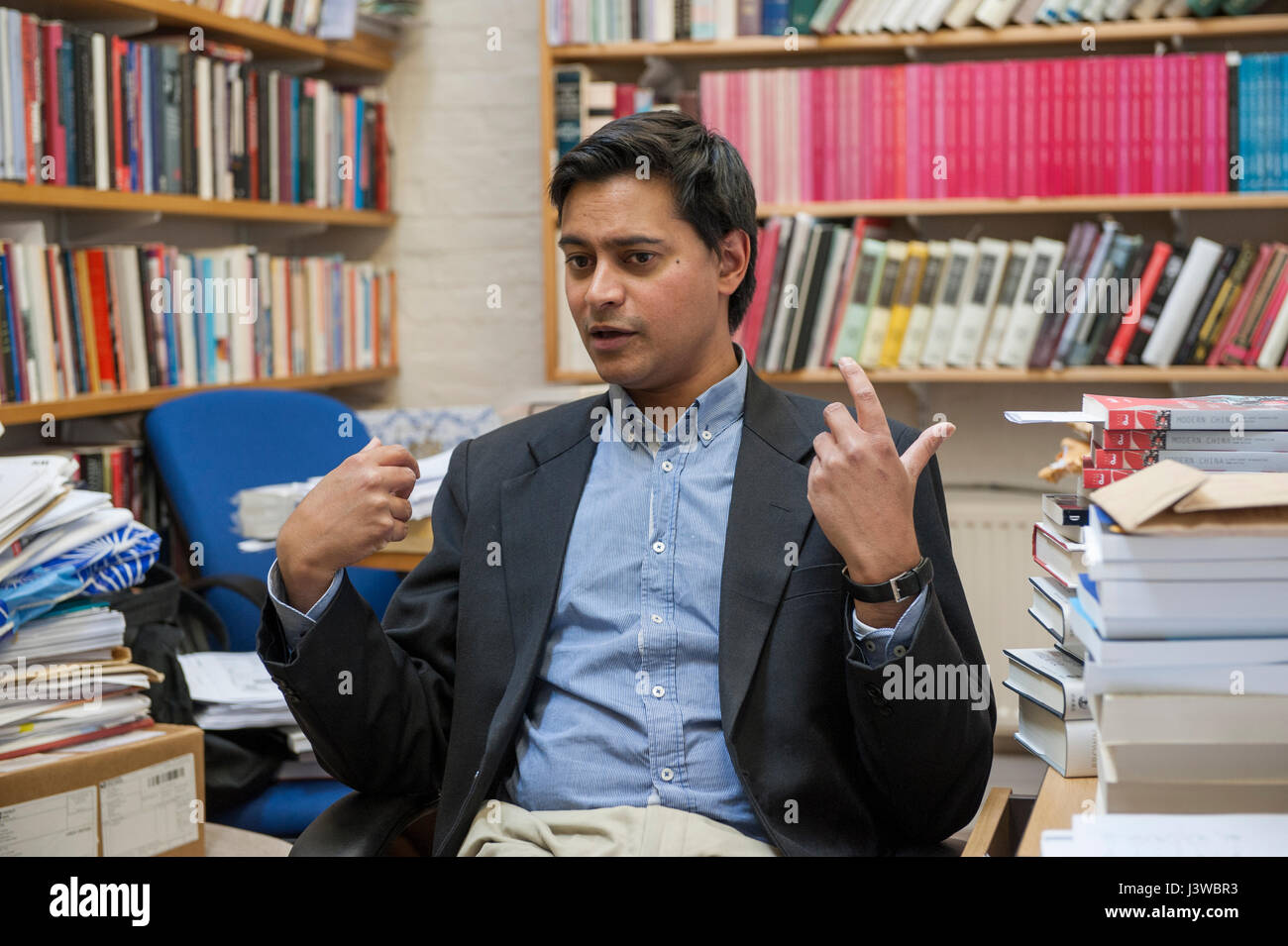 Rana Mitter surrounded by books at Oxford University Stock Photo - Alamy