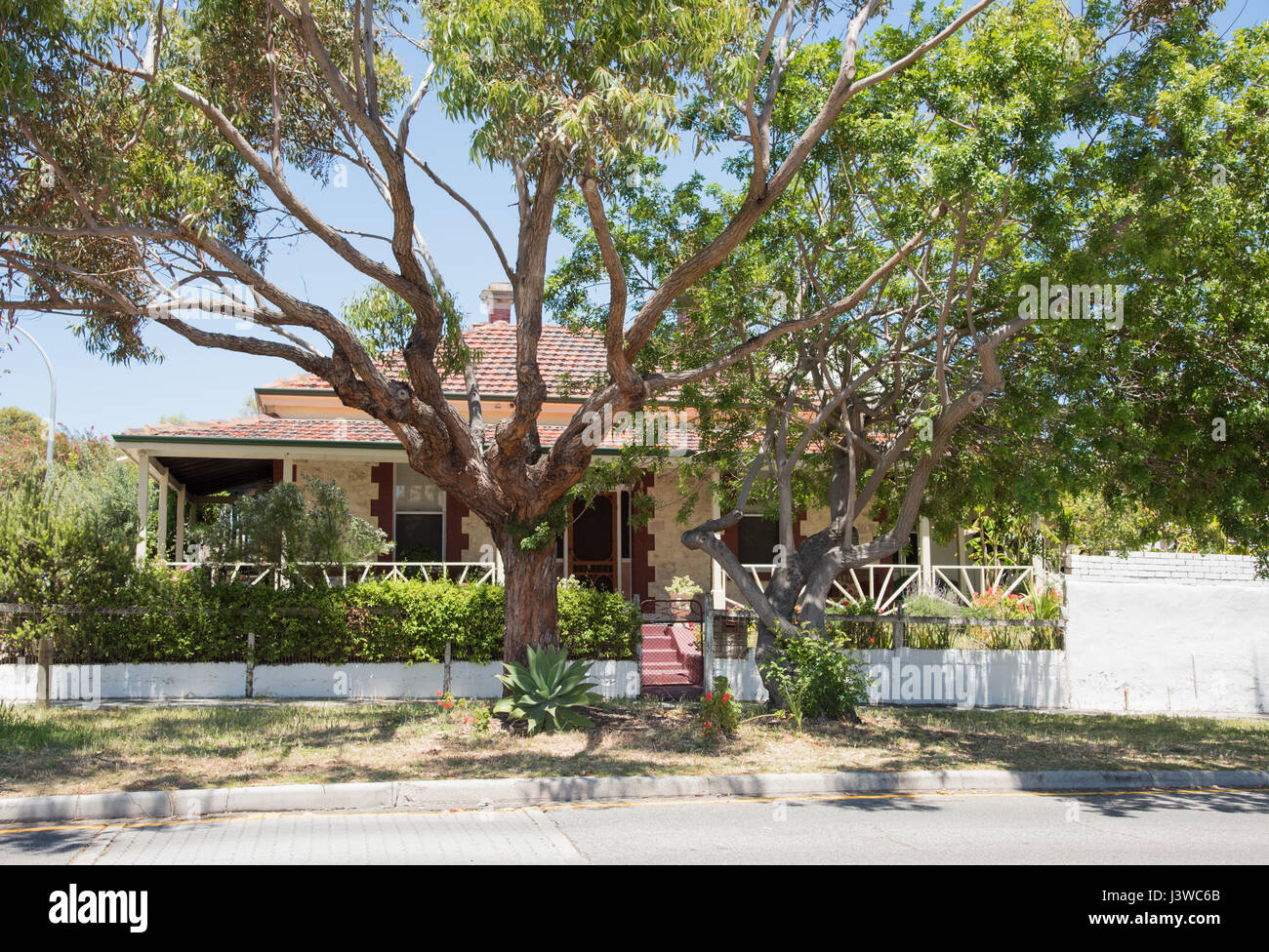 Quaint limestone cottage with lush front yard landscaping in the ...