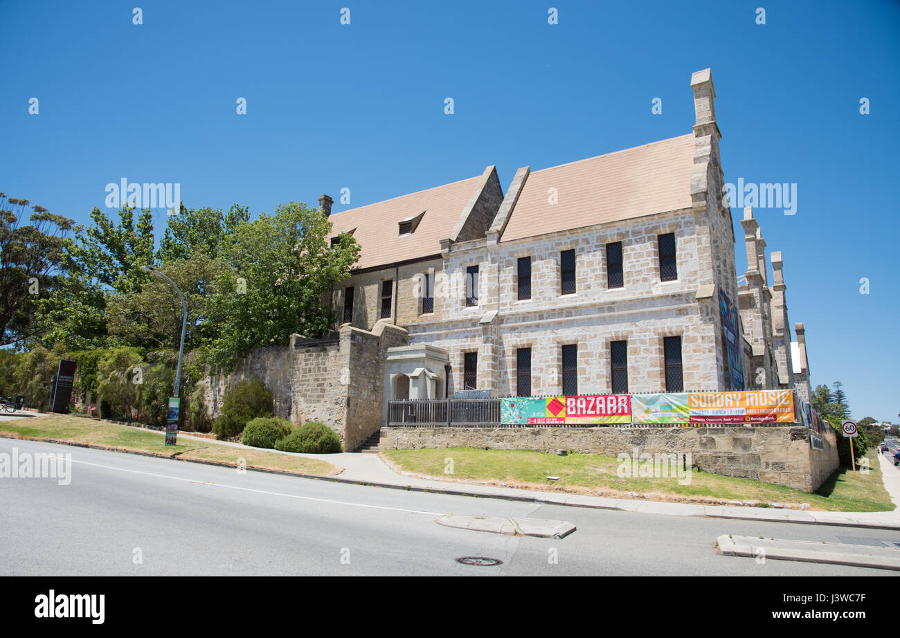 Limestone brick architecture of the Fremantle Arts Centre with posters ...