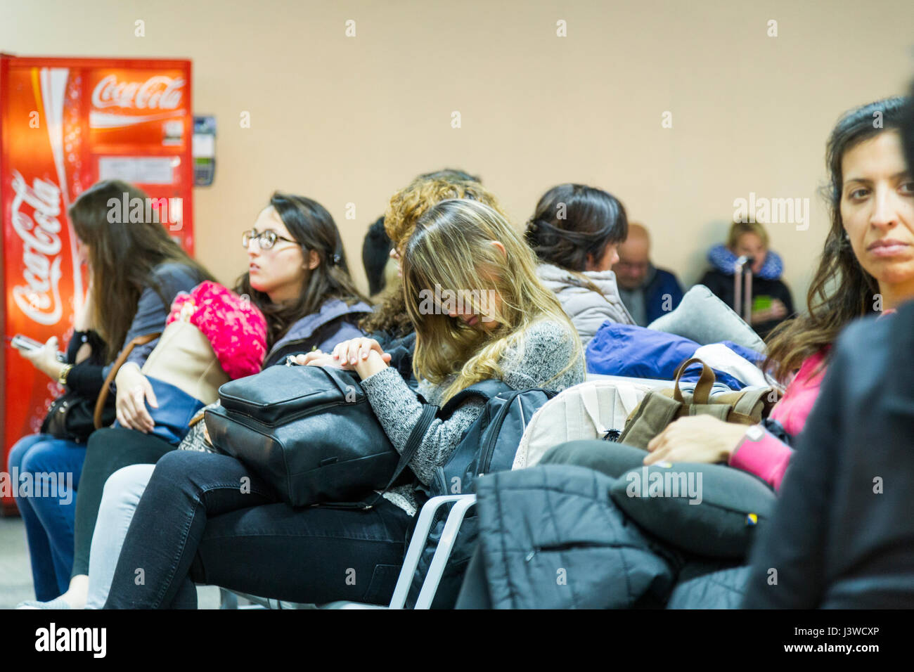 Tired woman sleeping airport hi-res stock photography and images - Alamy