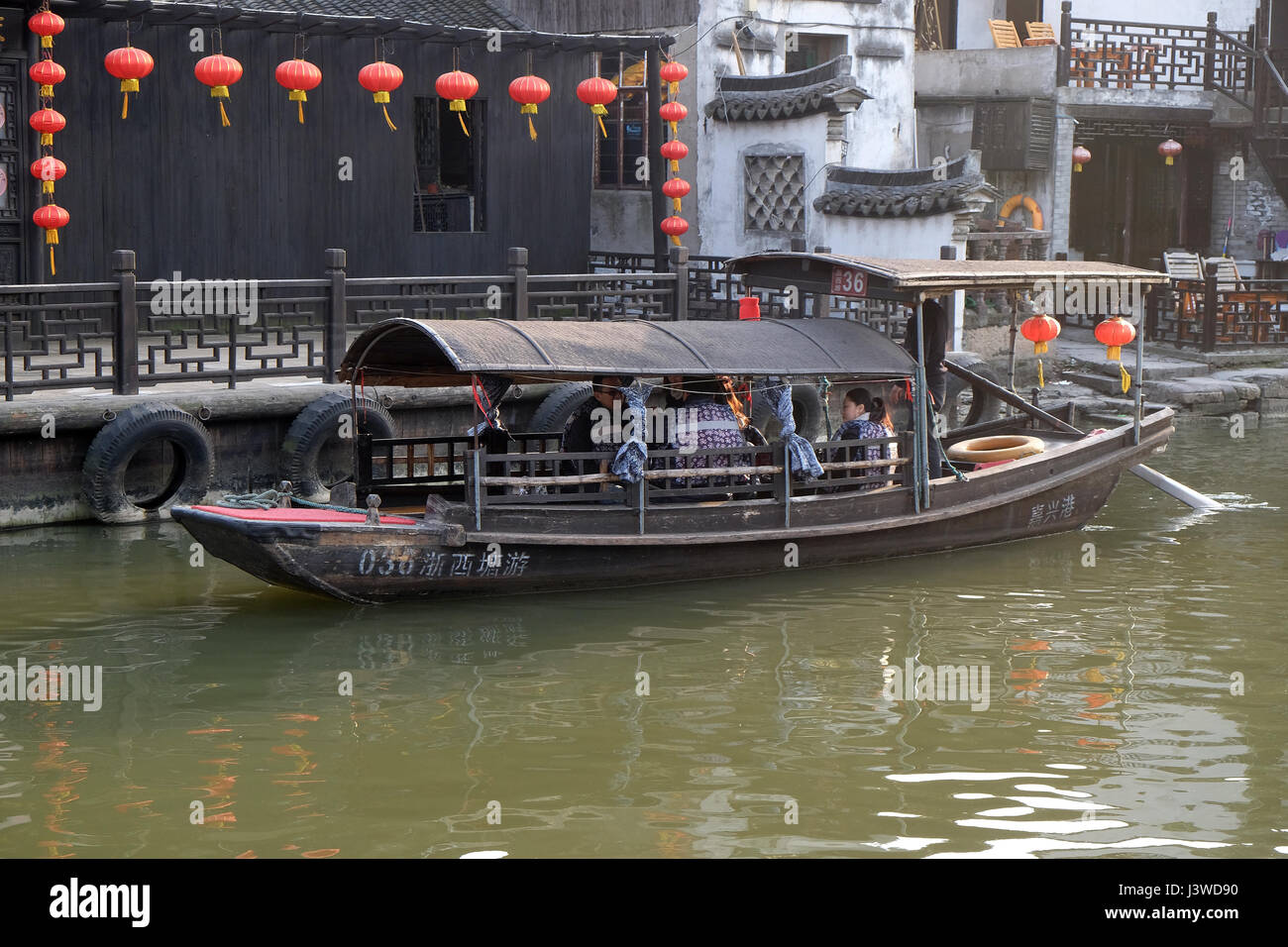 Tourist boats on the water canals of Xitang Town in Zhejiang Province ...