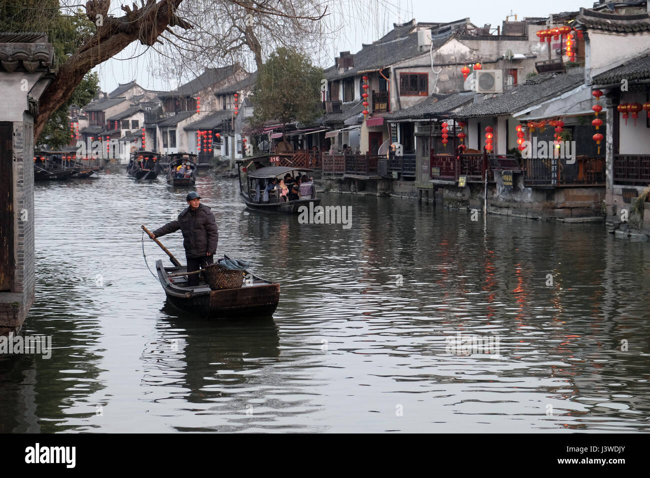 Tourist boats on the water canals of Xitang Town in Zhejiang Province ...