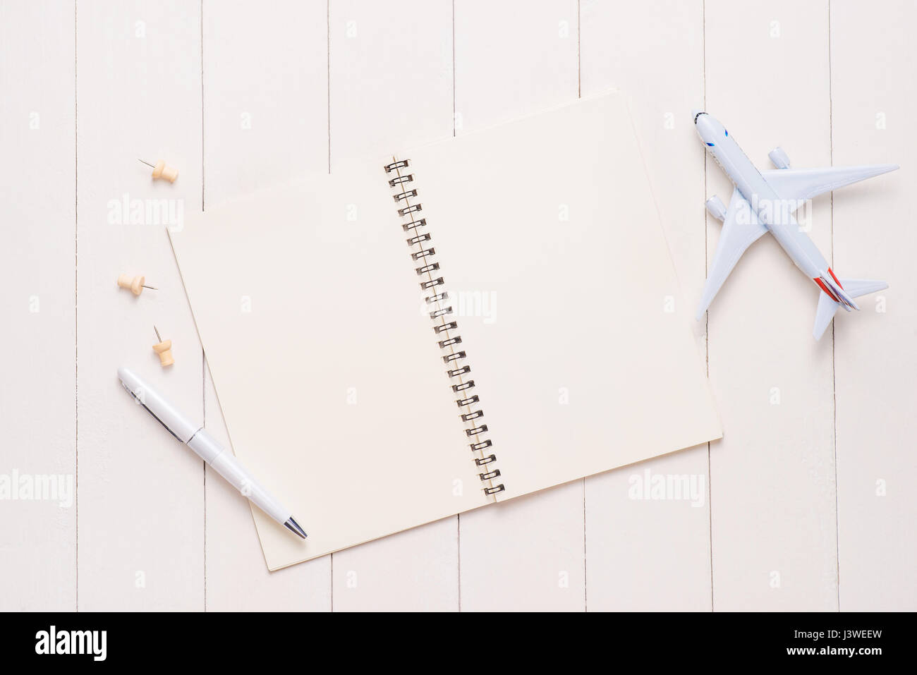 Business trip concept. Airplane and blank open notebook for your text ...