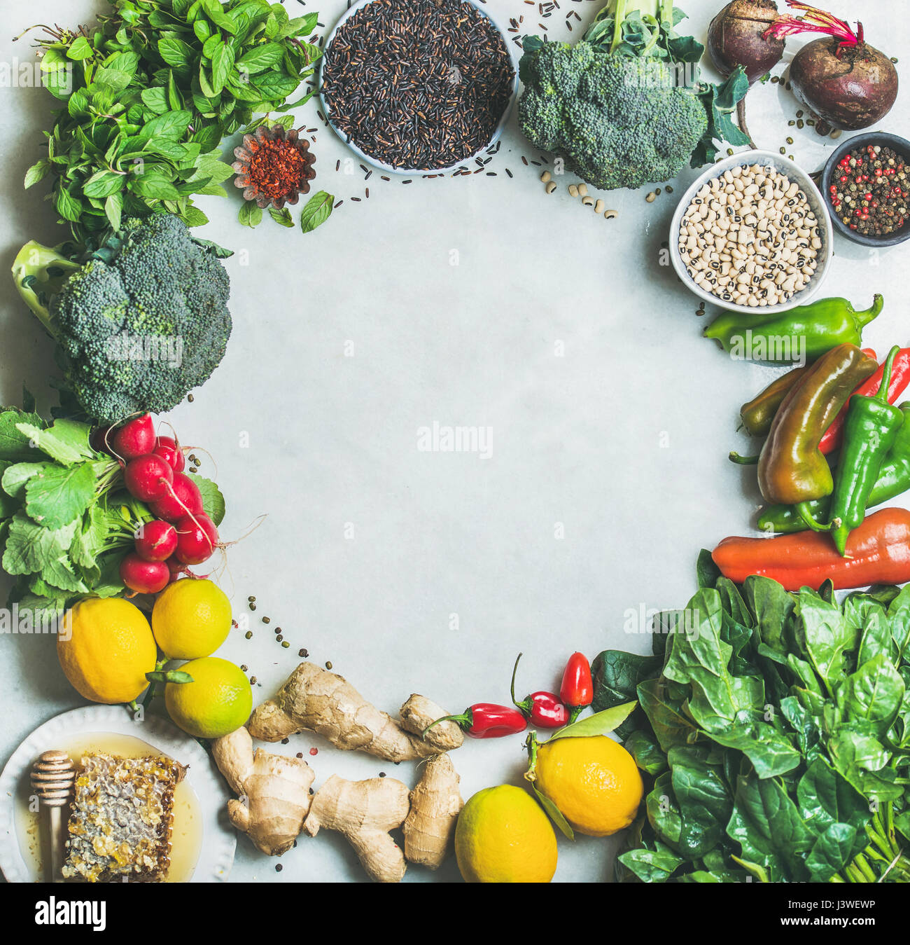 Clean eating healthy cooking ingredients over grey marble background ...