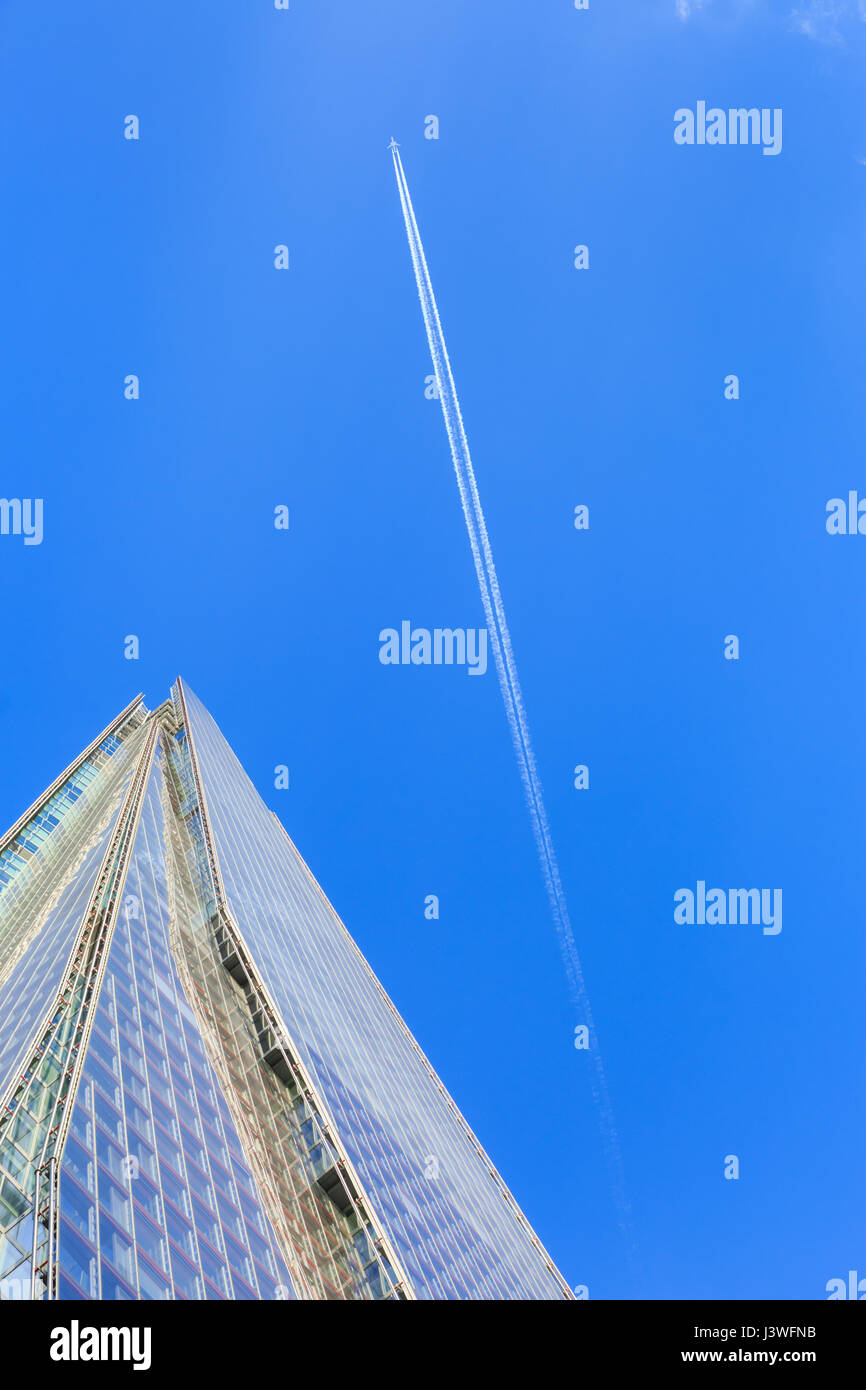 The Shard skyscraper from below with a plane going past, London Bridge ...