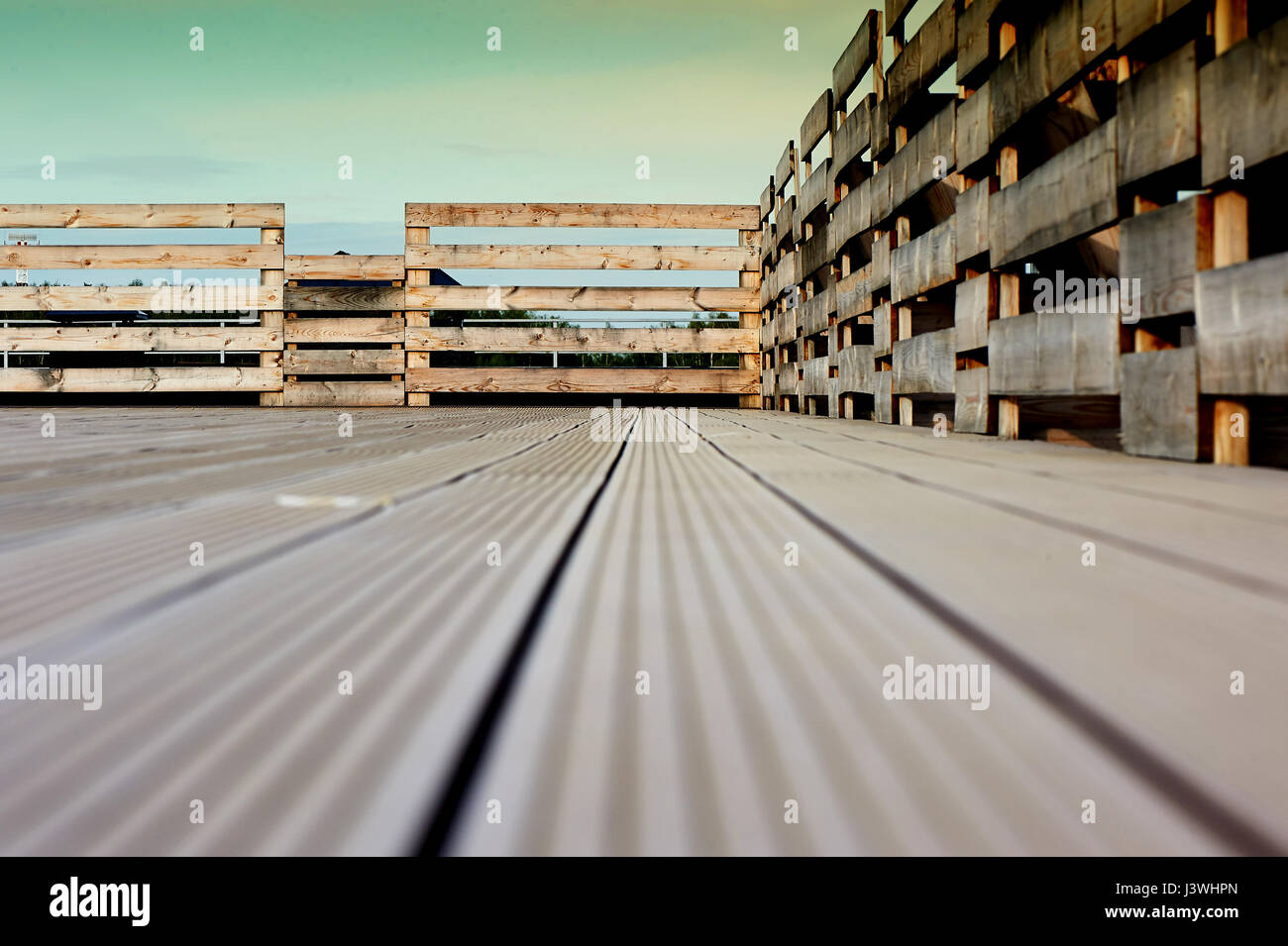 Decking and fence on a flat roof, against the sky, the forest and field ...