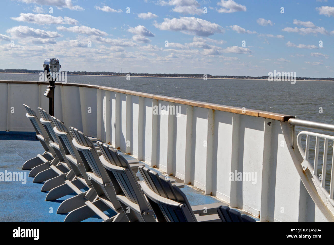 Ferry observation deck with chairs and a pay per view telescope as it ...