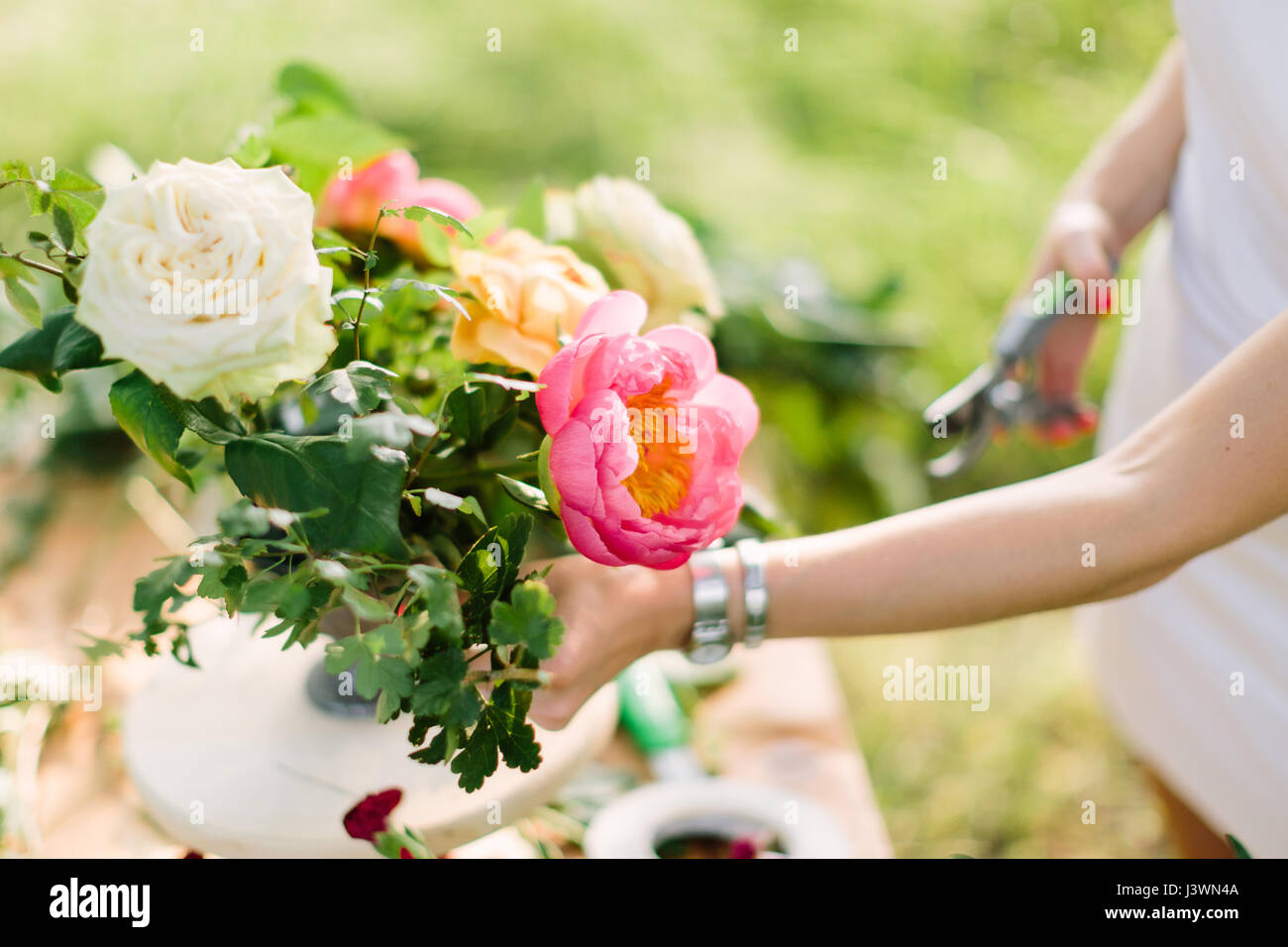 bouquet, people and floral arrangement concept - close-up on hands of ...