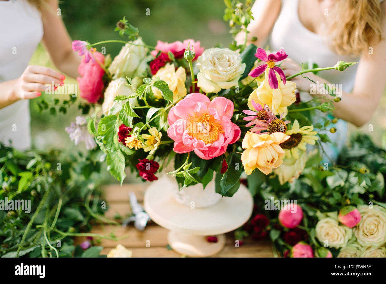 bouquet, people and floral arrangement concept - hands of two young ...