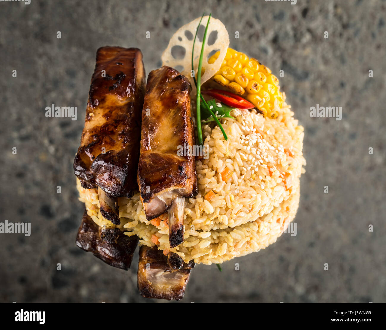 Chinese fried rice with ribs over concrete background Stock Photo - Alamy