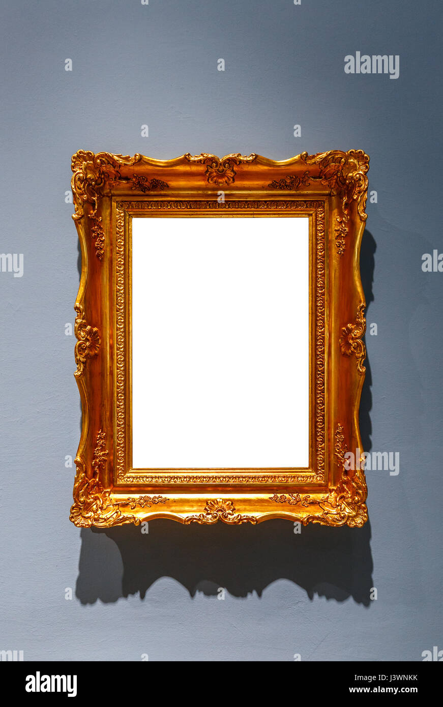 Antique golden frame hanging on the wall Stock Photo - Alamy