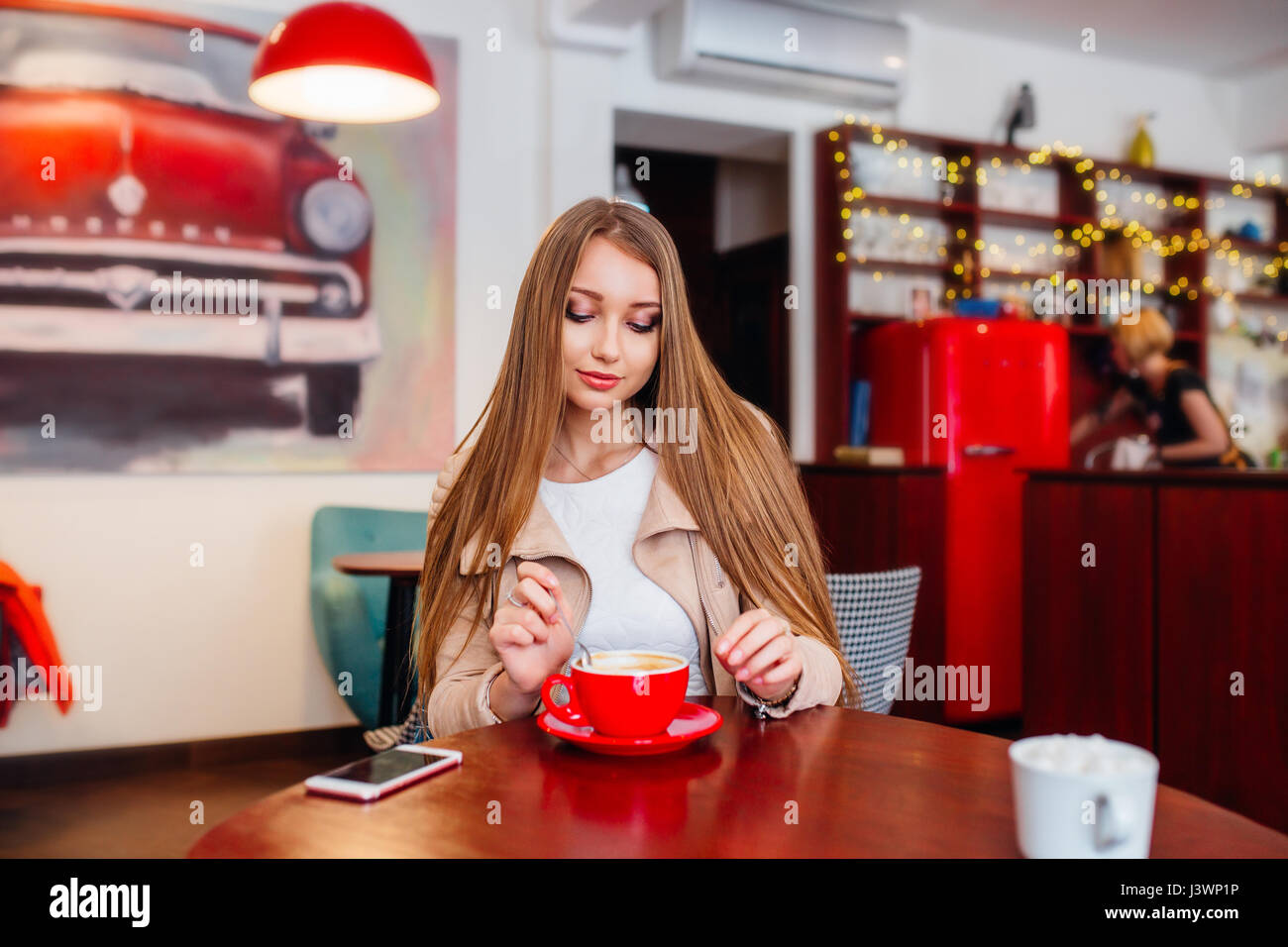 Beautiful cute girl in the cafe with coffee smiling Stock Photo - Alamy