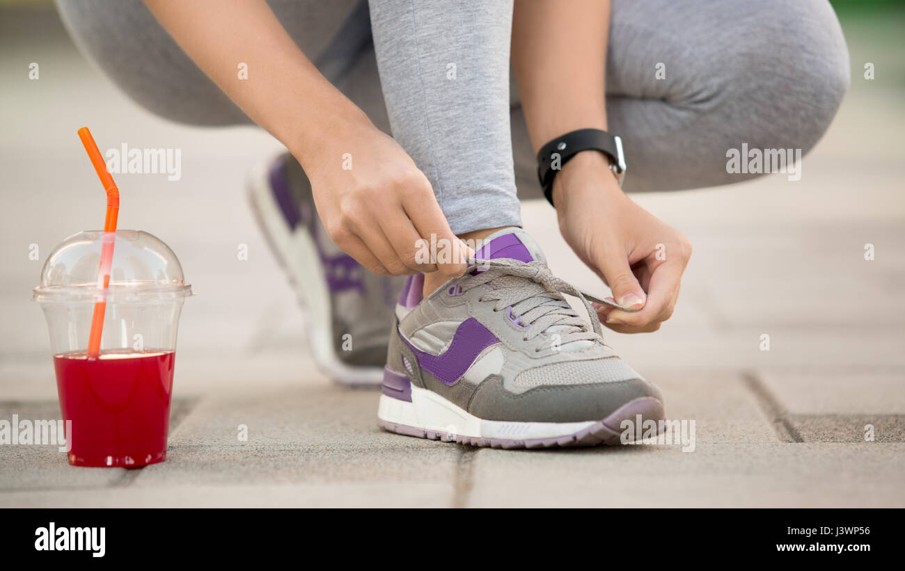 Young woman lace up snickers healthy sporty lifestyle Stock Photo - Alamy