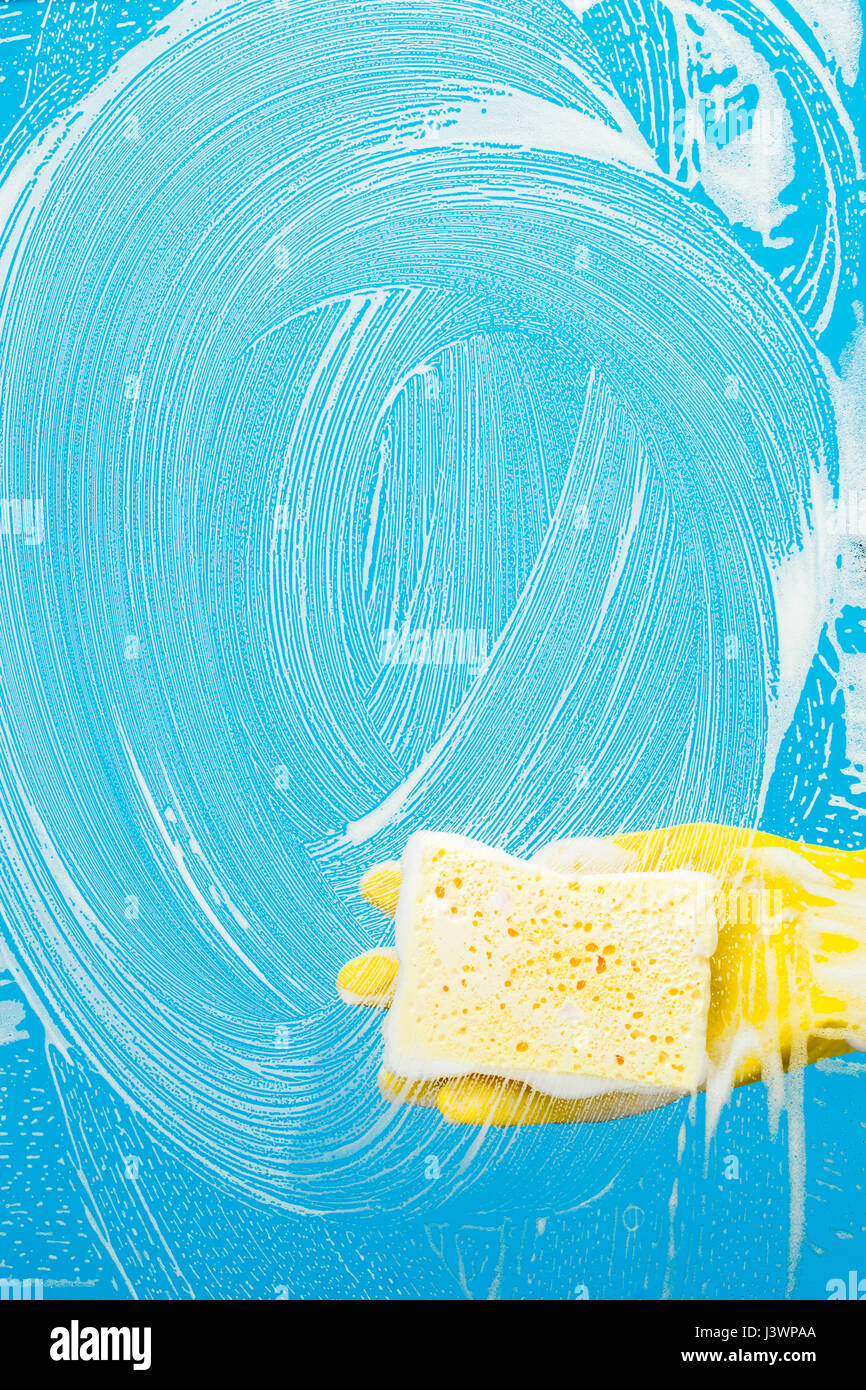 Man with sponge cleaning window Stock Photo - Alamy