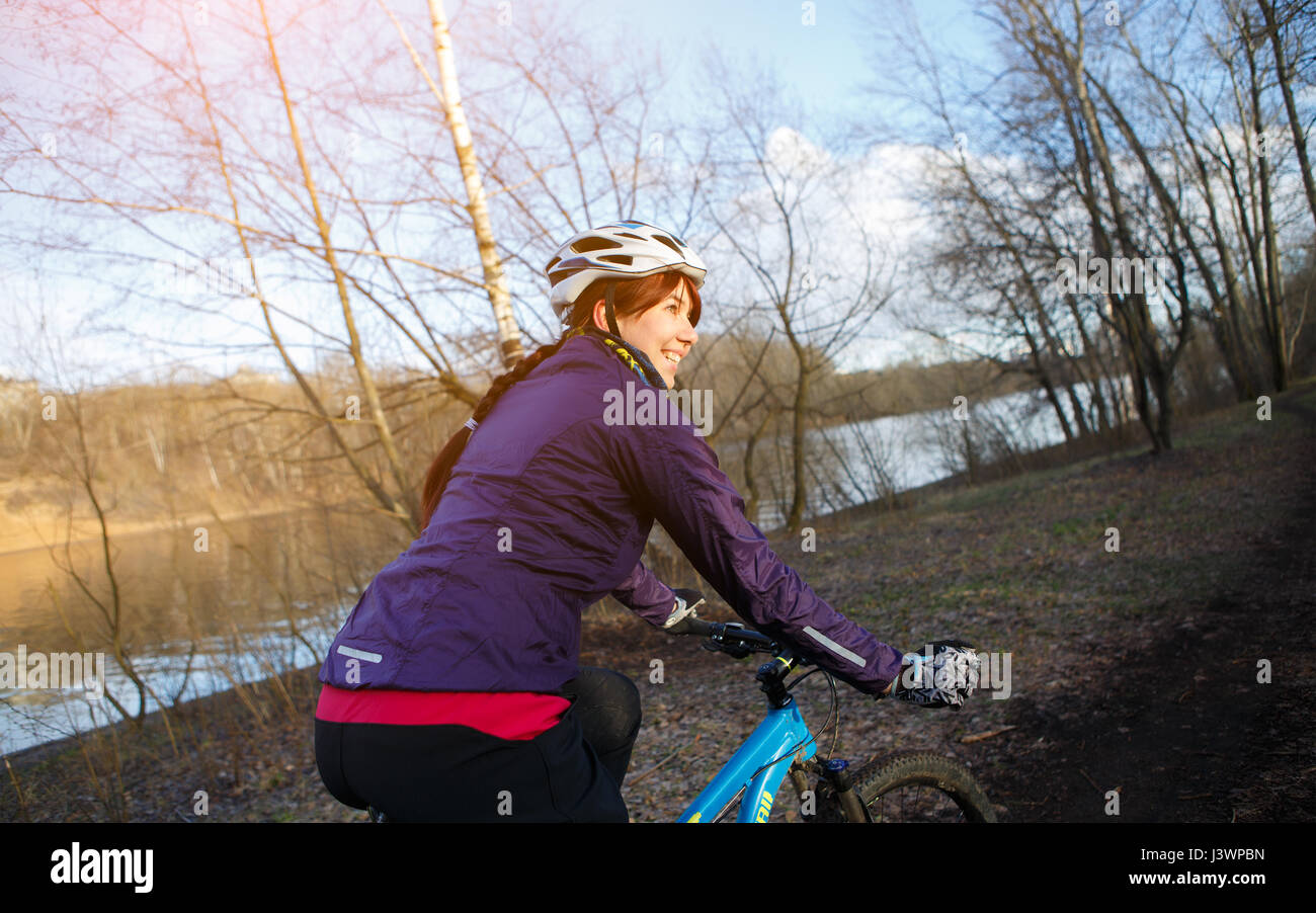 Athlete rides bicycle through park Stock Photo - Alamy