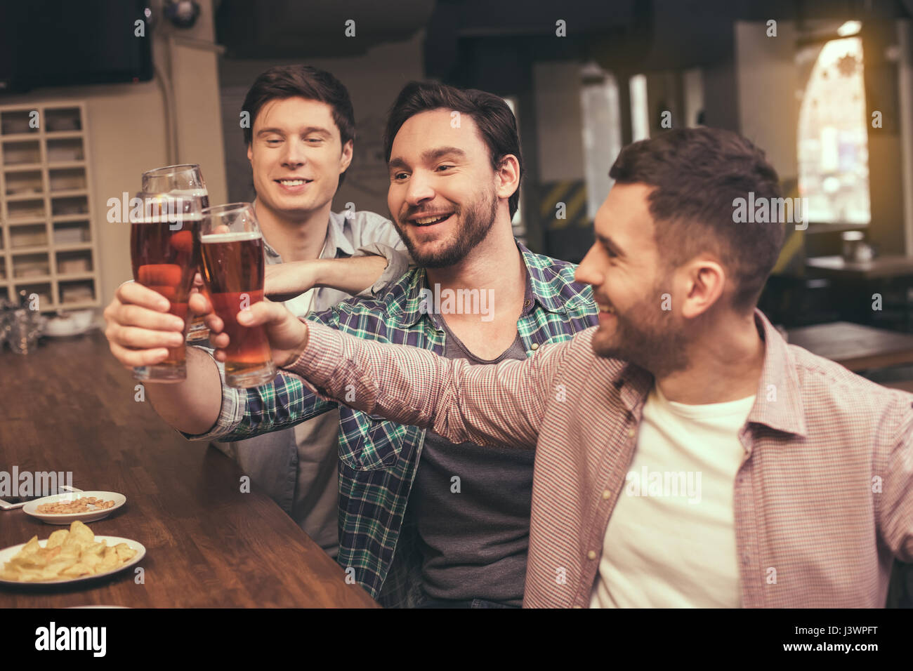 Friends having fun in pub Stock Photo - Alamy