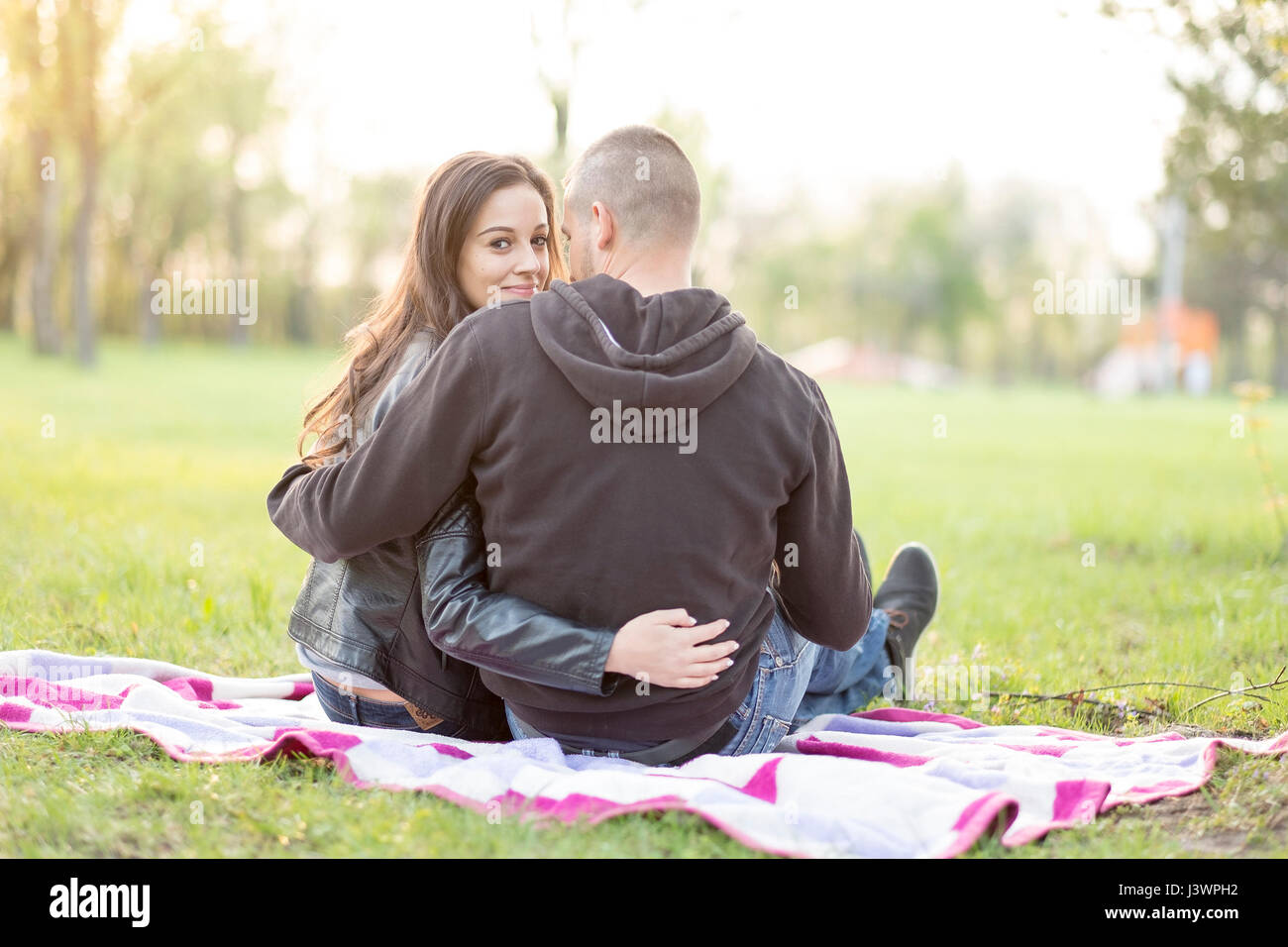 Romantic couple date love in park at sunset Stock Photo - Alamy