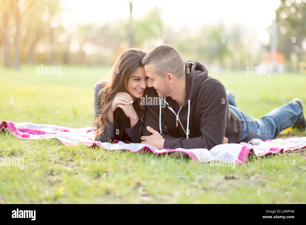 Romantic couple love in park at sunset Stock Photo - Alamy
