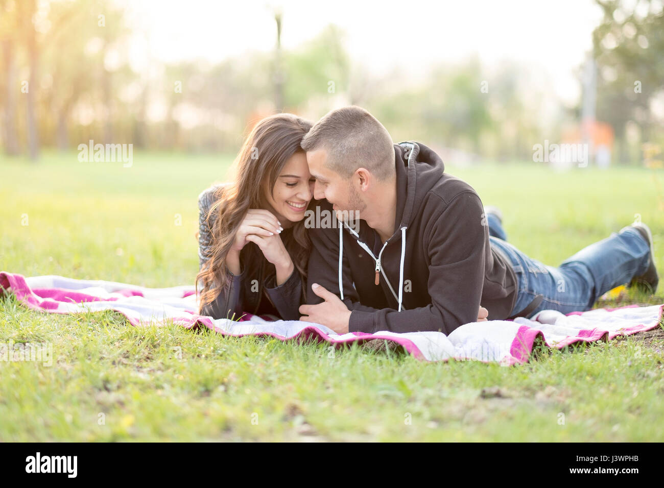 Romantic couple date love in park at sunset Stock Photo - Alamy