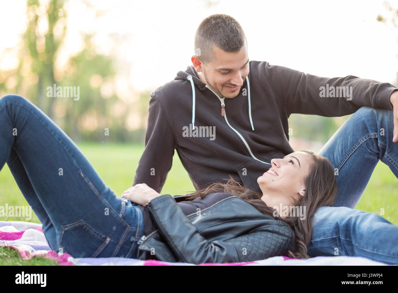Romantic couple date love in park at sunset Stock Photo - Alamy