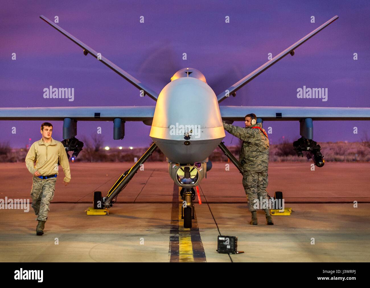 U.S. soldiers secure a USAF MQ-9 Reaper unmanned aerial vehicle ...