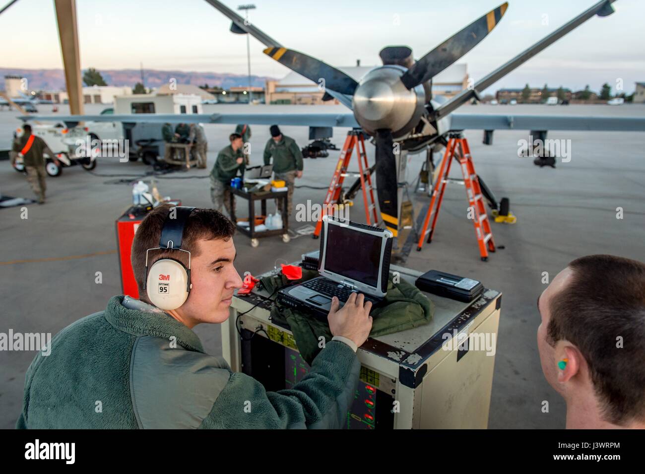 U.S. soldiers inspect a USAF MQ-9 Reaper unmanned aerial vehicle ...