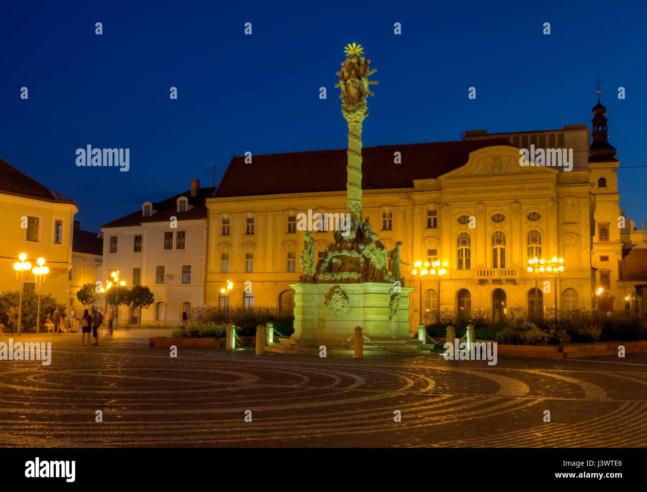 Plague column on Holy Trinity square by night in Trnava, Slovakia Stock ...